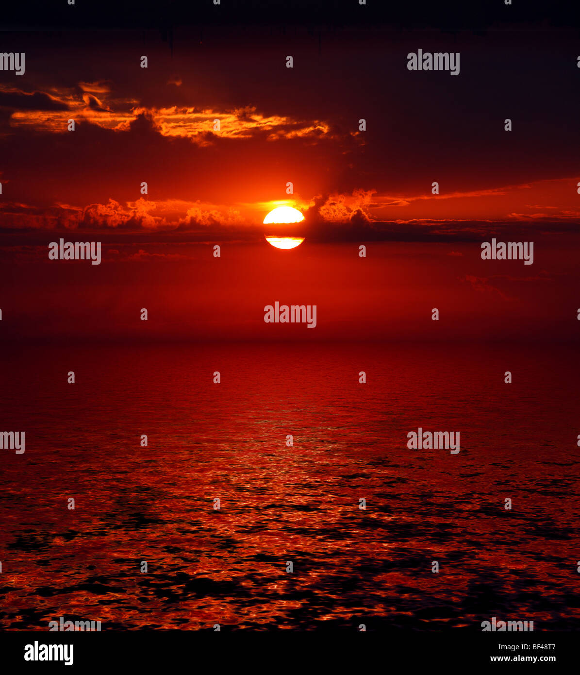 dramatic red sunrise on dark sky with clouds Stock Photo - Alamy