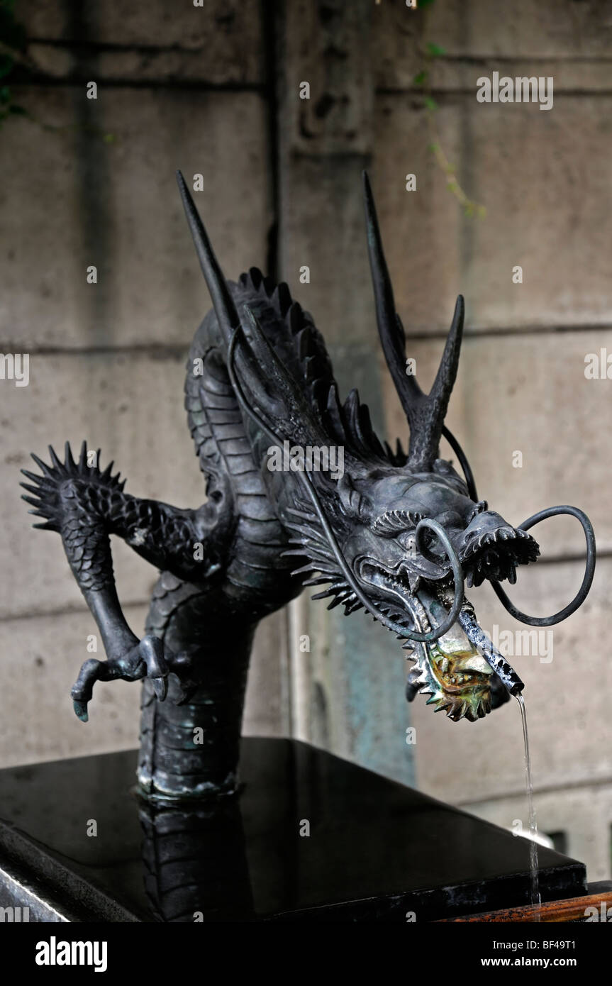 An intricately carved and detailed dragon shaped water fountain with in ...