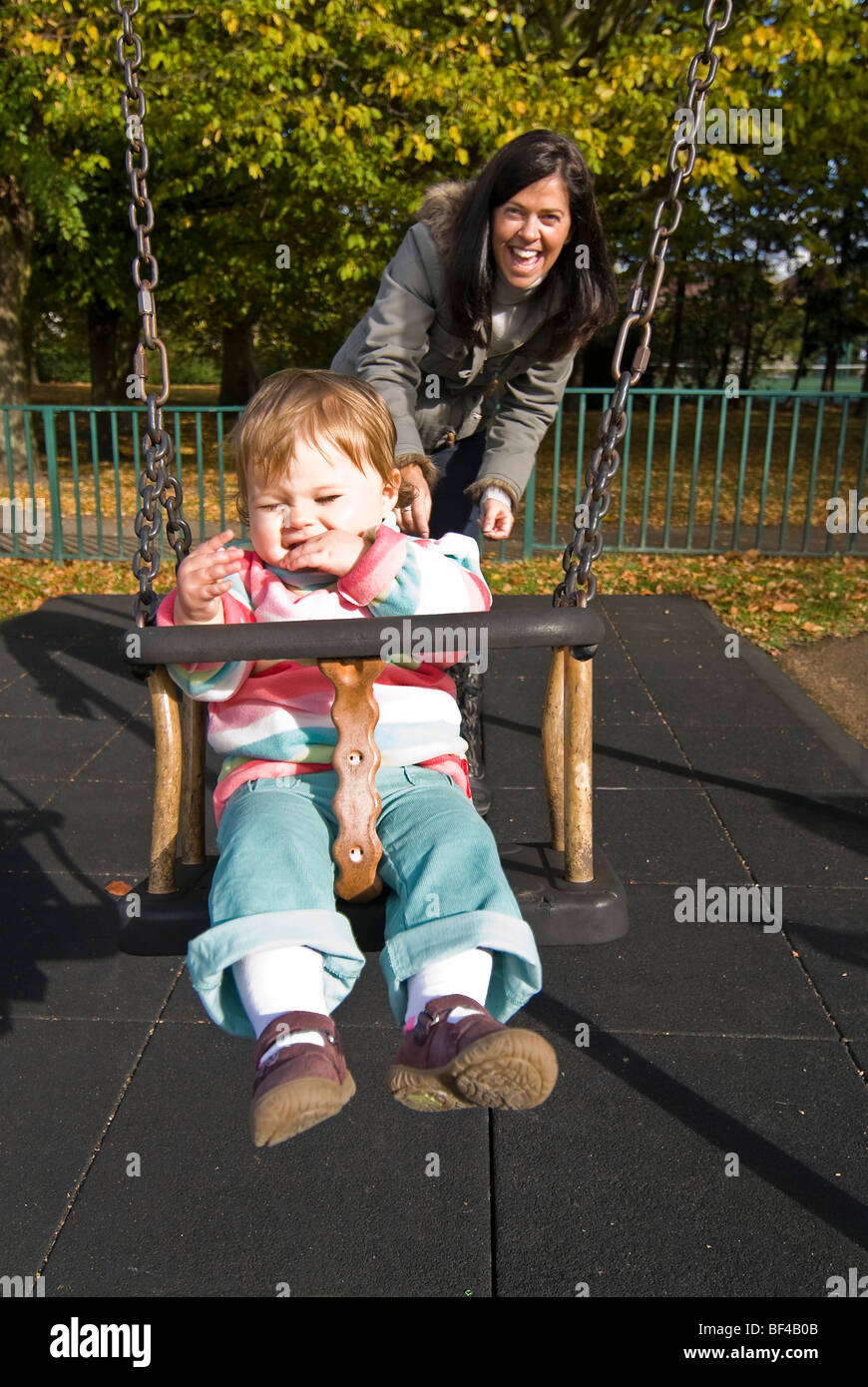 Happy smiling smile fun funny push swing swings playground hi-res stock ...