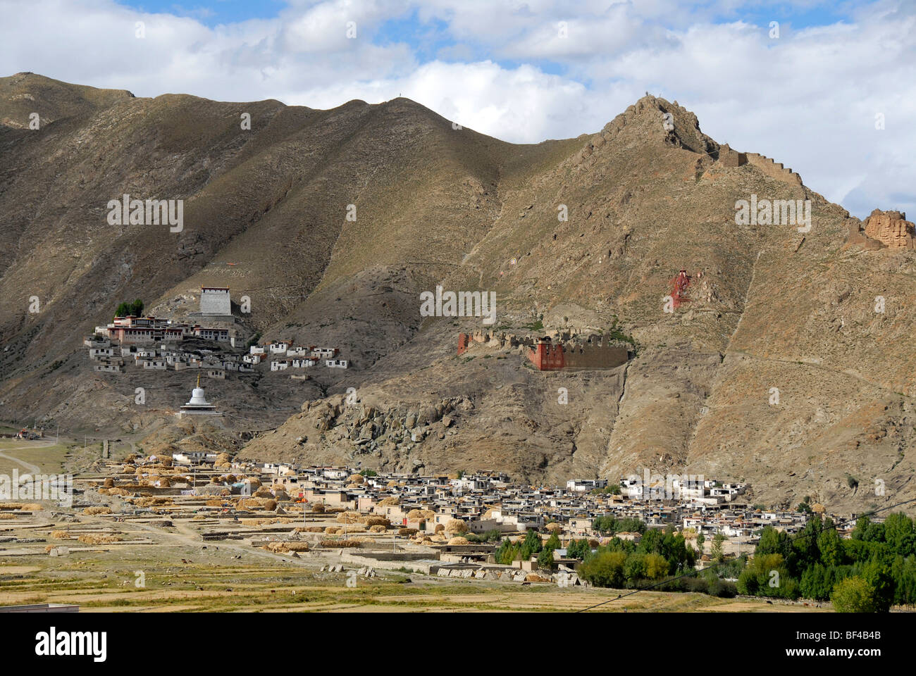 Tibetan landscape, village with a monastery, stupa and fortress on ...