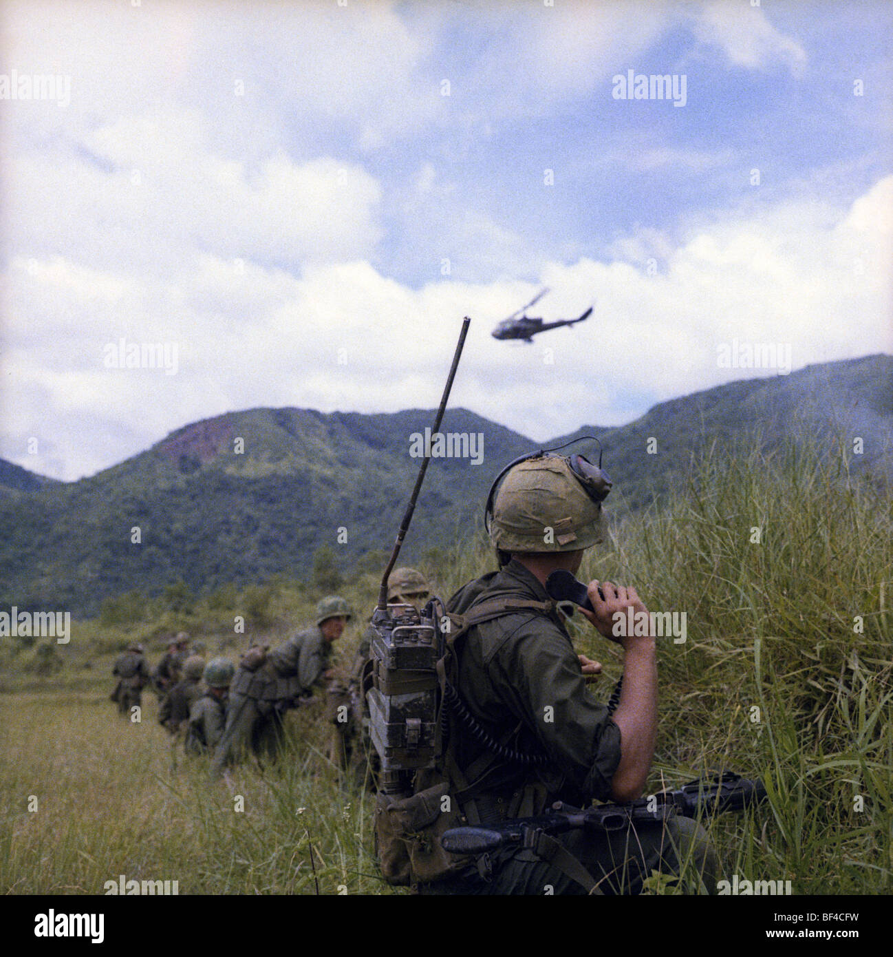 Members of B Troop, 1st Squadron, 9th Cavalry watch a huey helicopter ...