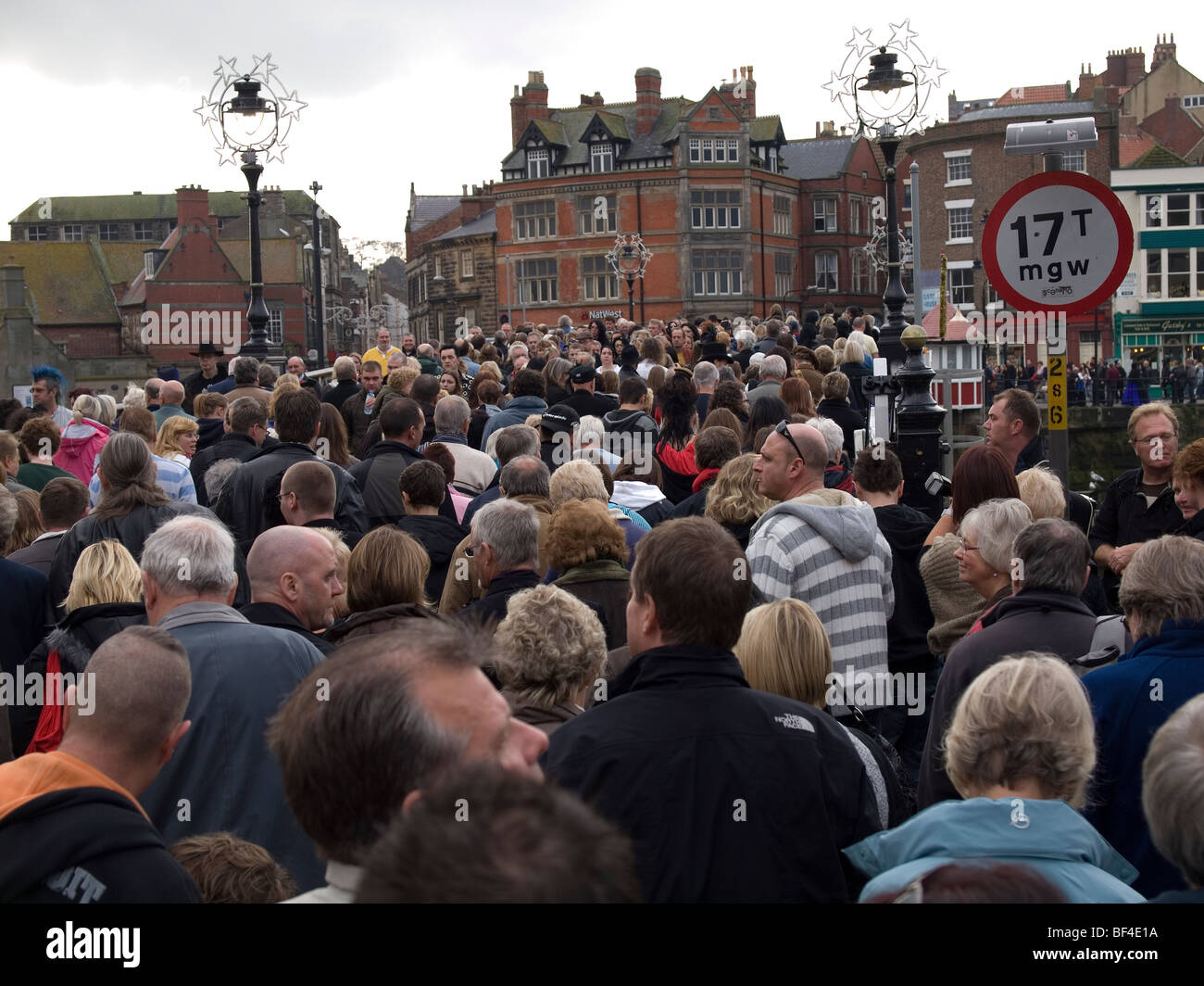A dense crowd of people crossing the swing bridge at the Whitby Goth ...