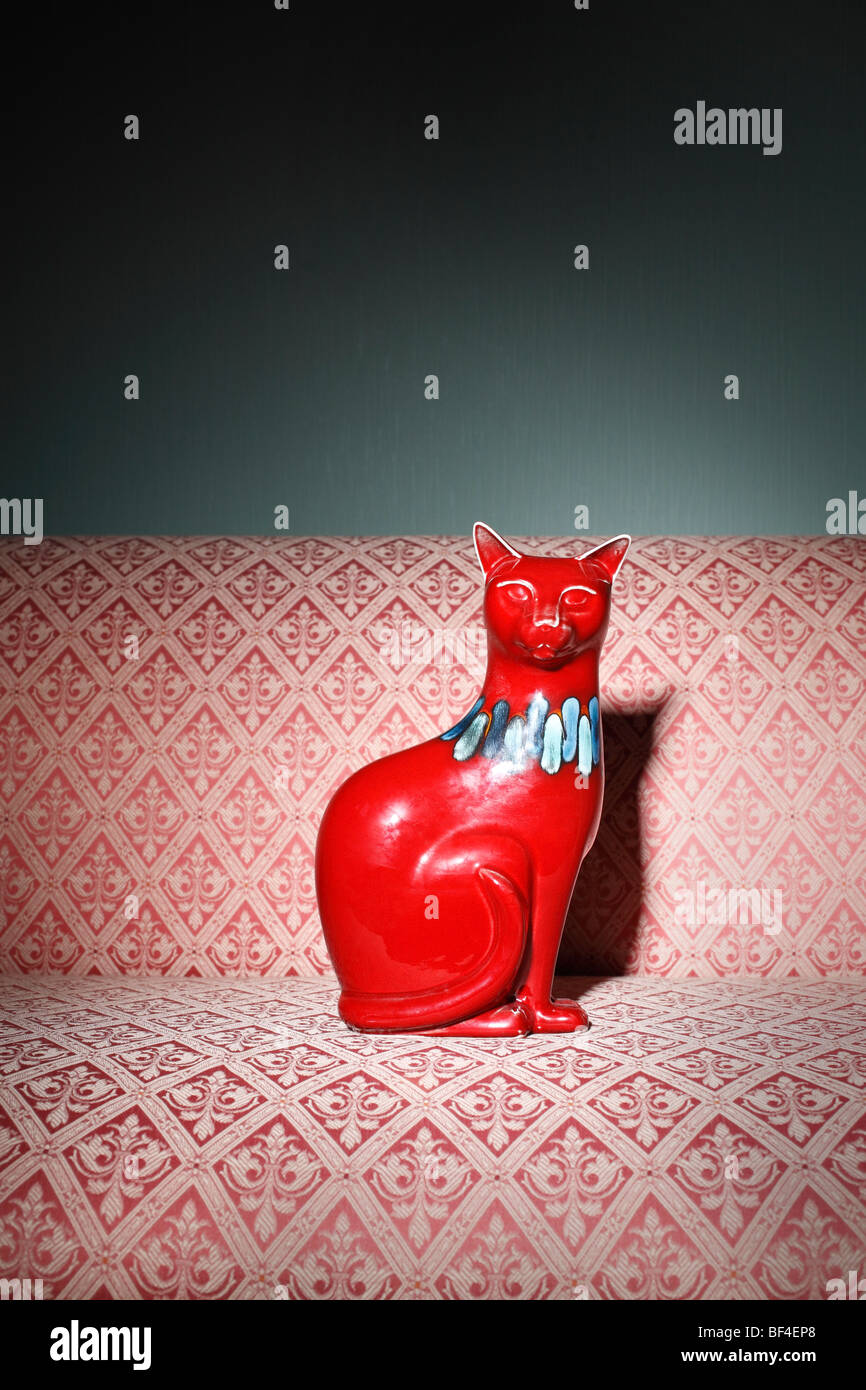 red porcelain cat on antique sofa Stock Photo - Alamy