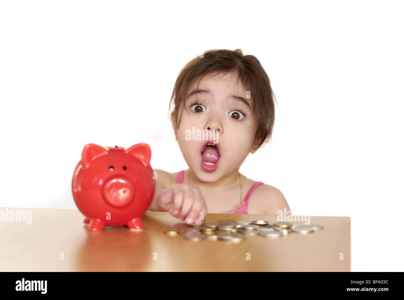Child with Piggy Bank and coins Stock Photo - Alamy