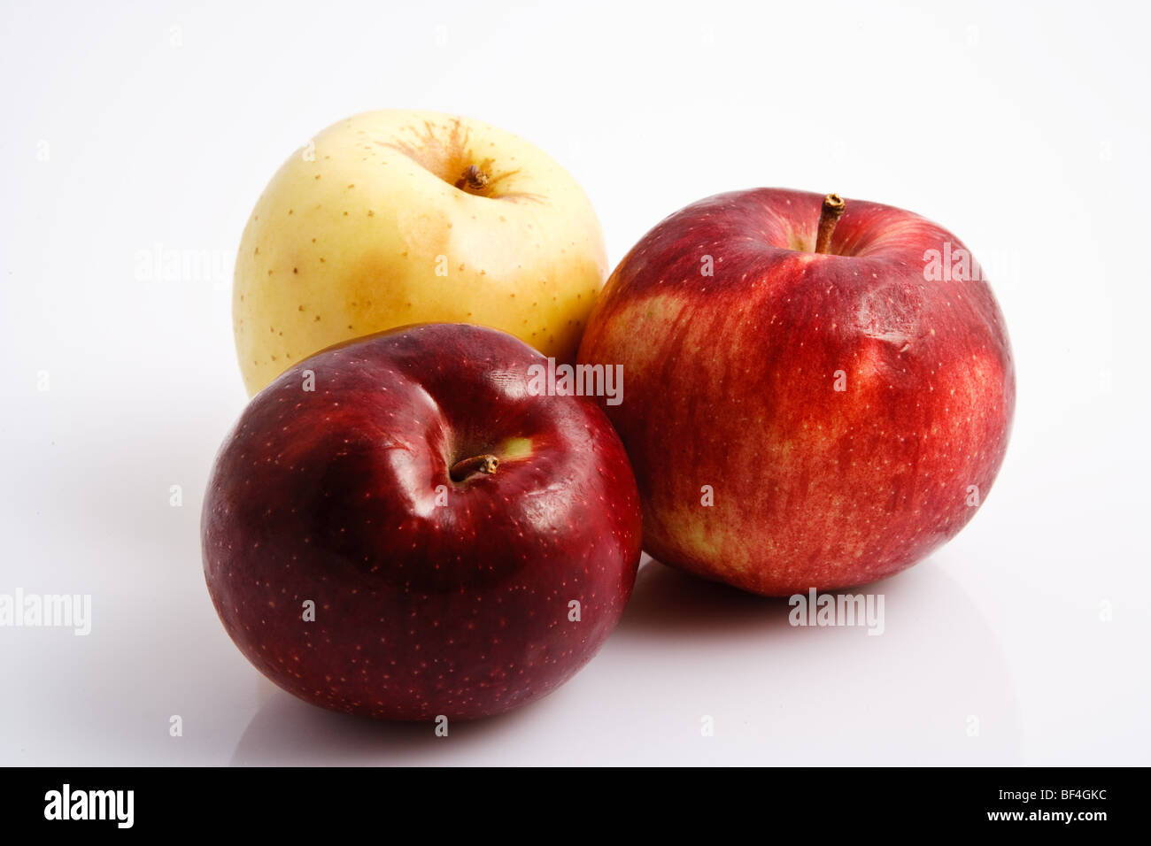 Three apples on a white background Stock Photo - Alamy