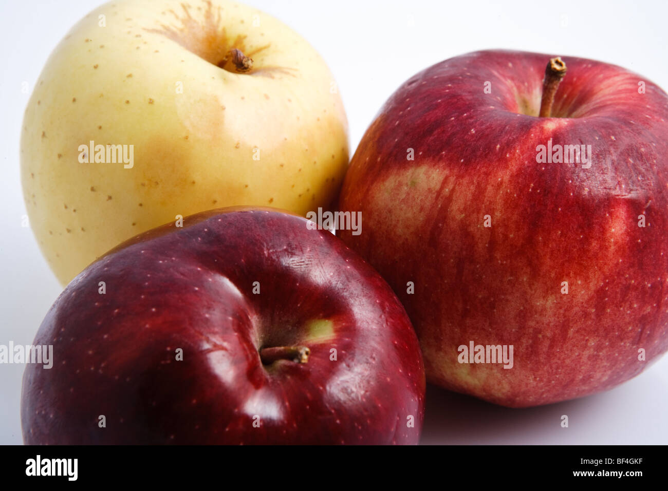 Three apples on a white background Stock Photo - Alamy