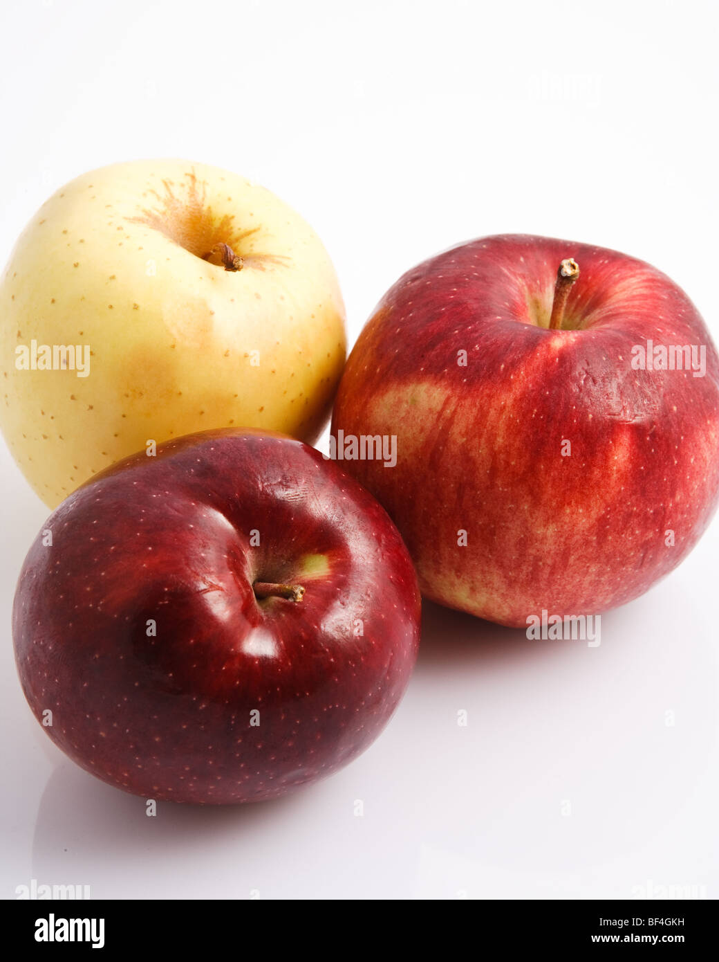 Three apples on a white background Stock Photo - Alamy