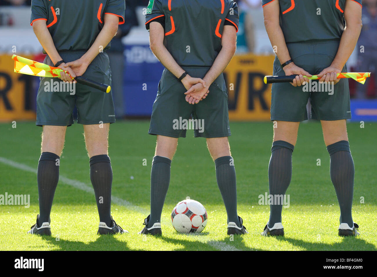 Referee and two linesmen, ball, flag during a minute's silence in the ...