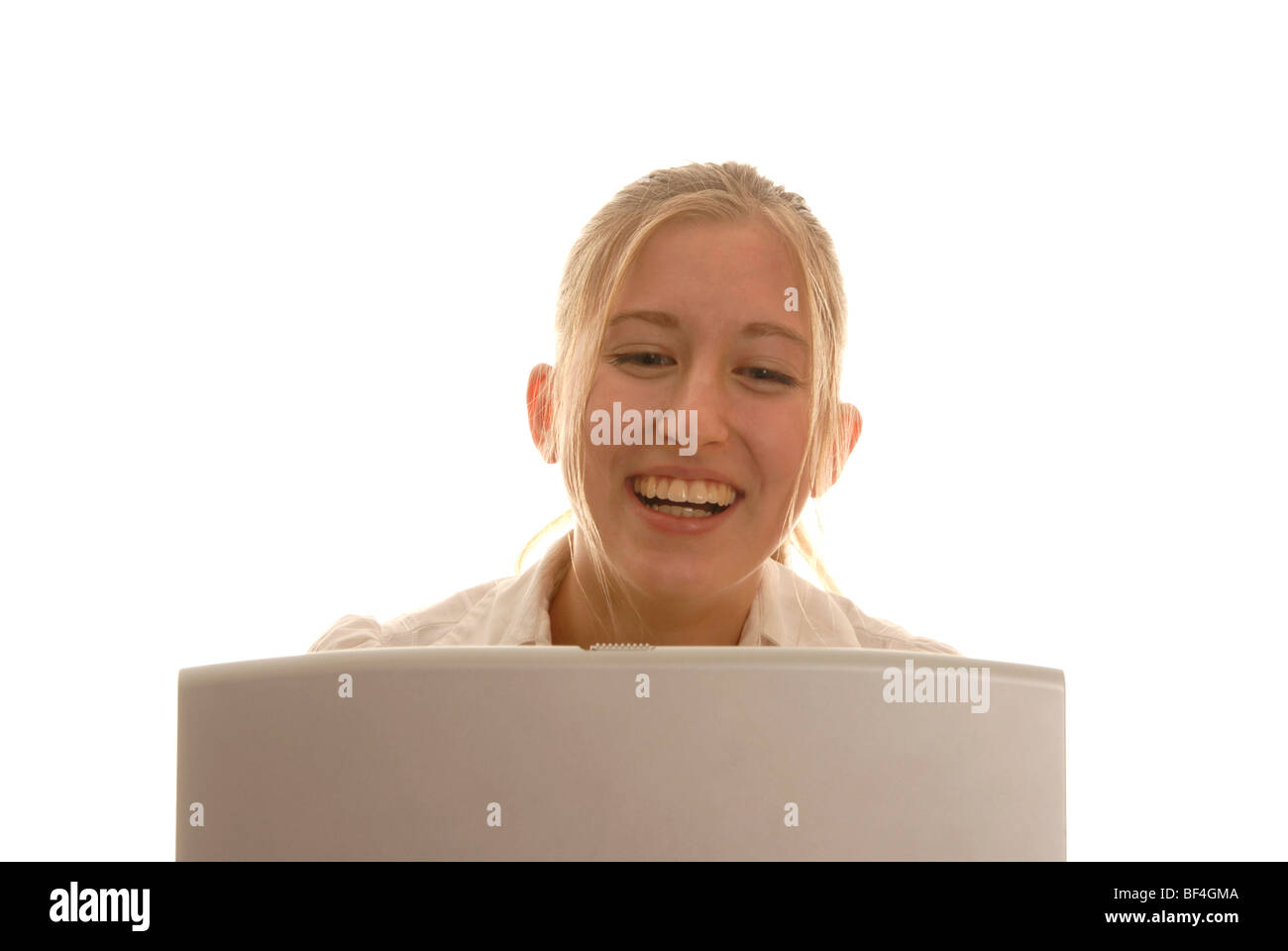 Eighteen year old woman behind a laptop, smiling Stock Photo - Alamy