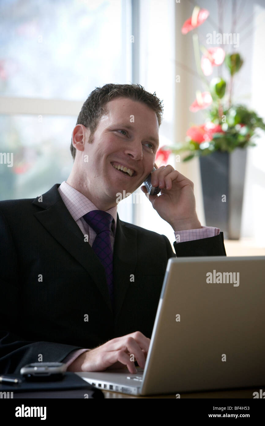Business man sat at a office desk Stock Photo - Alamy