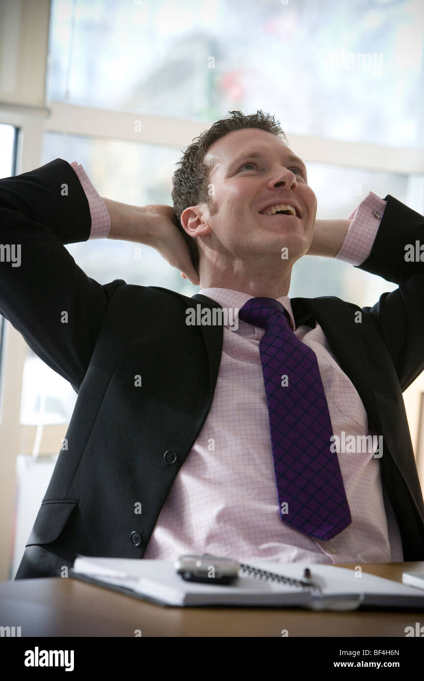 Business man sat at a office desk Stock Photo - Alamy
