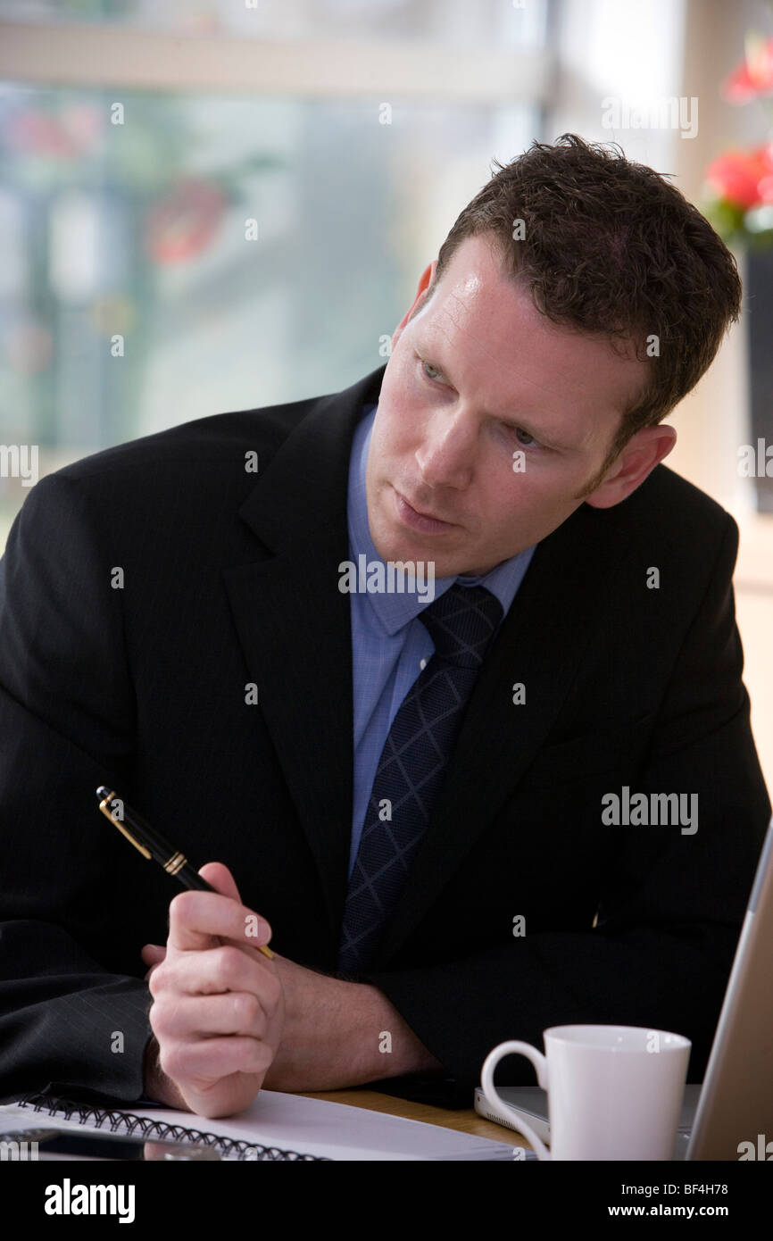 Business man sat at a office desk Stock Photo - Alamy