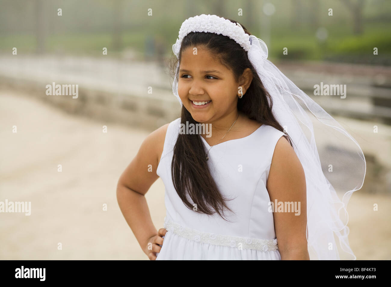 Hispanic girl wearing first communion gown and veil Stock Photo - Alamy