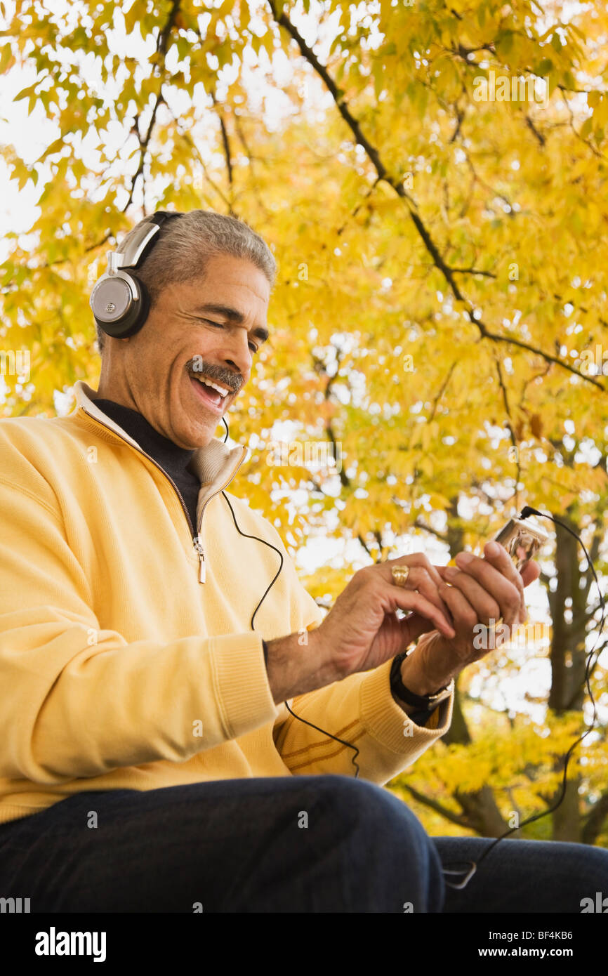 African man listening to mp3 player Stock Photo - Alamy