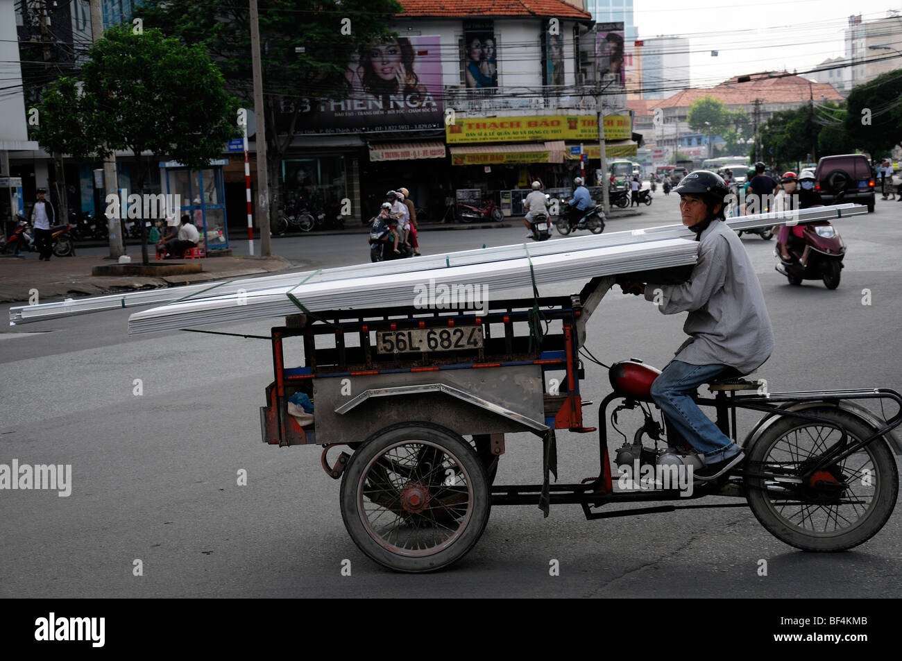 man carrying transporting carry transport very heavy load overloaded ...