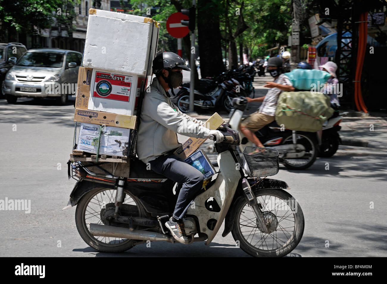 man carrying transporting carry transport very heavy load overloaded ...