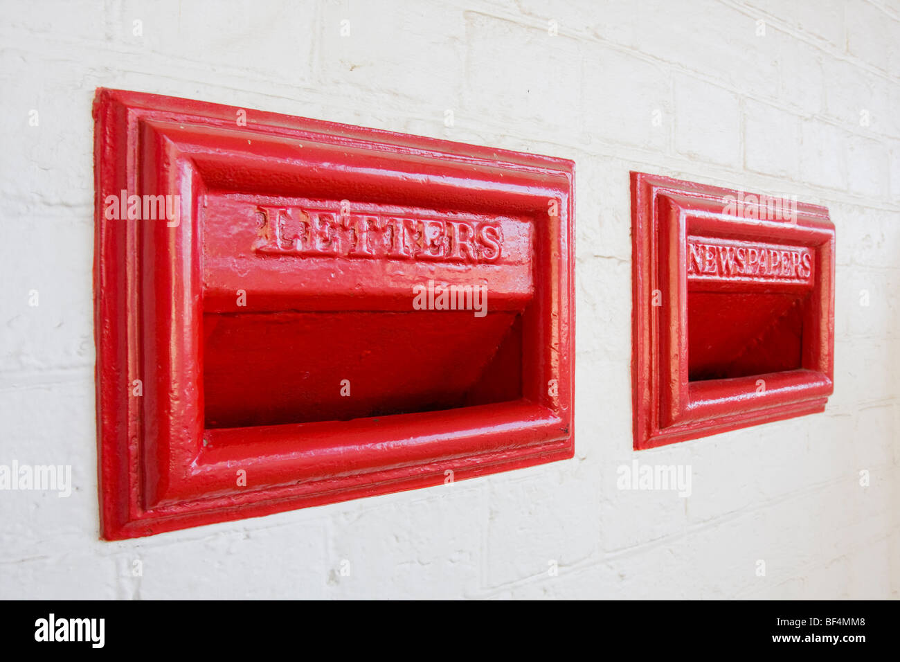 Red letterbox and Newspaper box in old style inset into brick wall ...