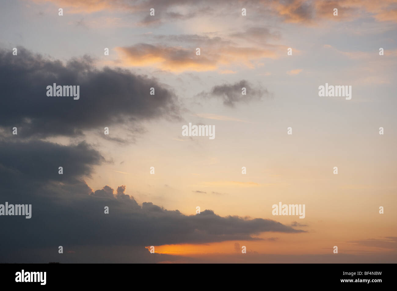 cloudy sky and sunset with orange and dark clouds Stock Photo - Alamy