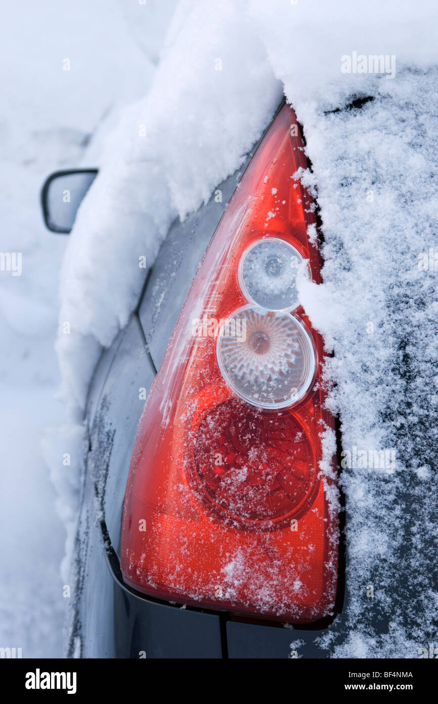 Rear lights of a parked car covered in snow Stock Photo - Alamy