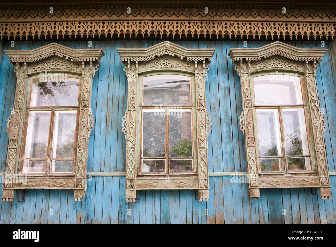 Traditional wooden house exterior with ornately carved window frames ...