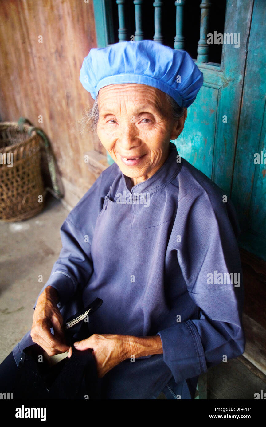 Elderly Gelao ethnic minority woman sewing, Shiqian County, Guizhou ...