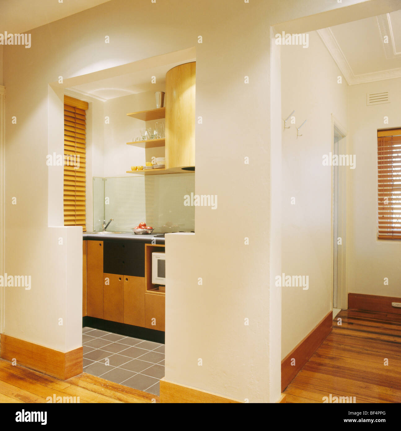 Modern open-plan white hall with doorway to compact kitchen Stock Photo ...