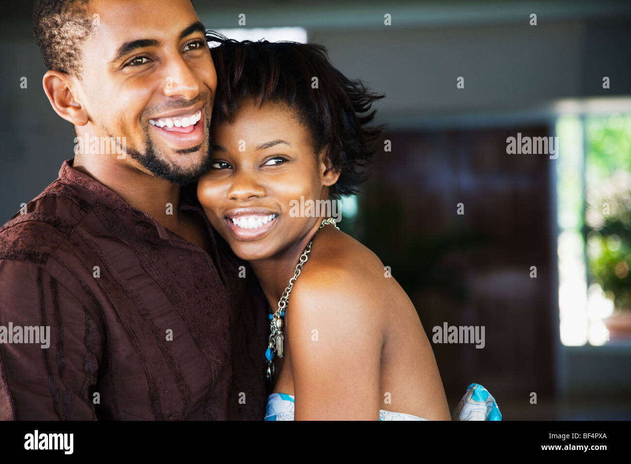 African couple hugging Stock Photo - Alamy