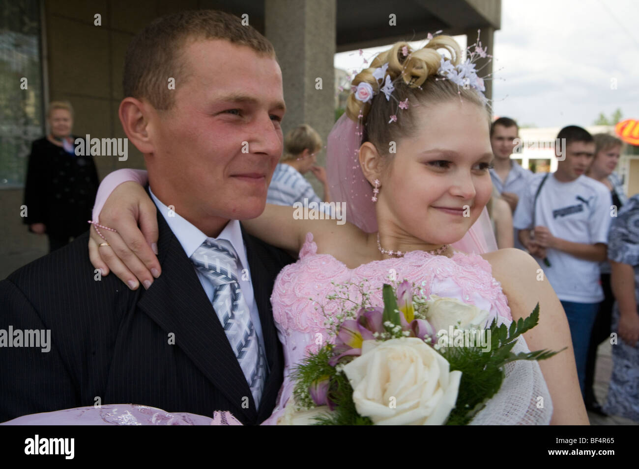 Groom carrying bride at reception, Ekaterinburg, Uralmash, Russia Stock ...