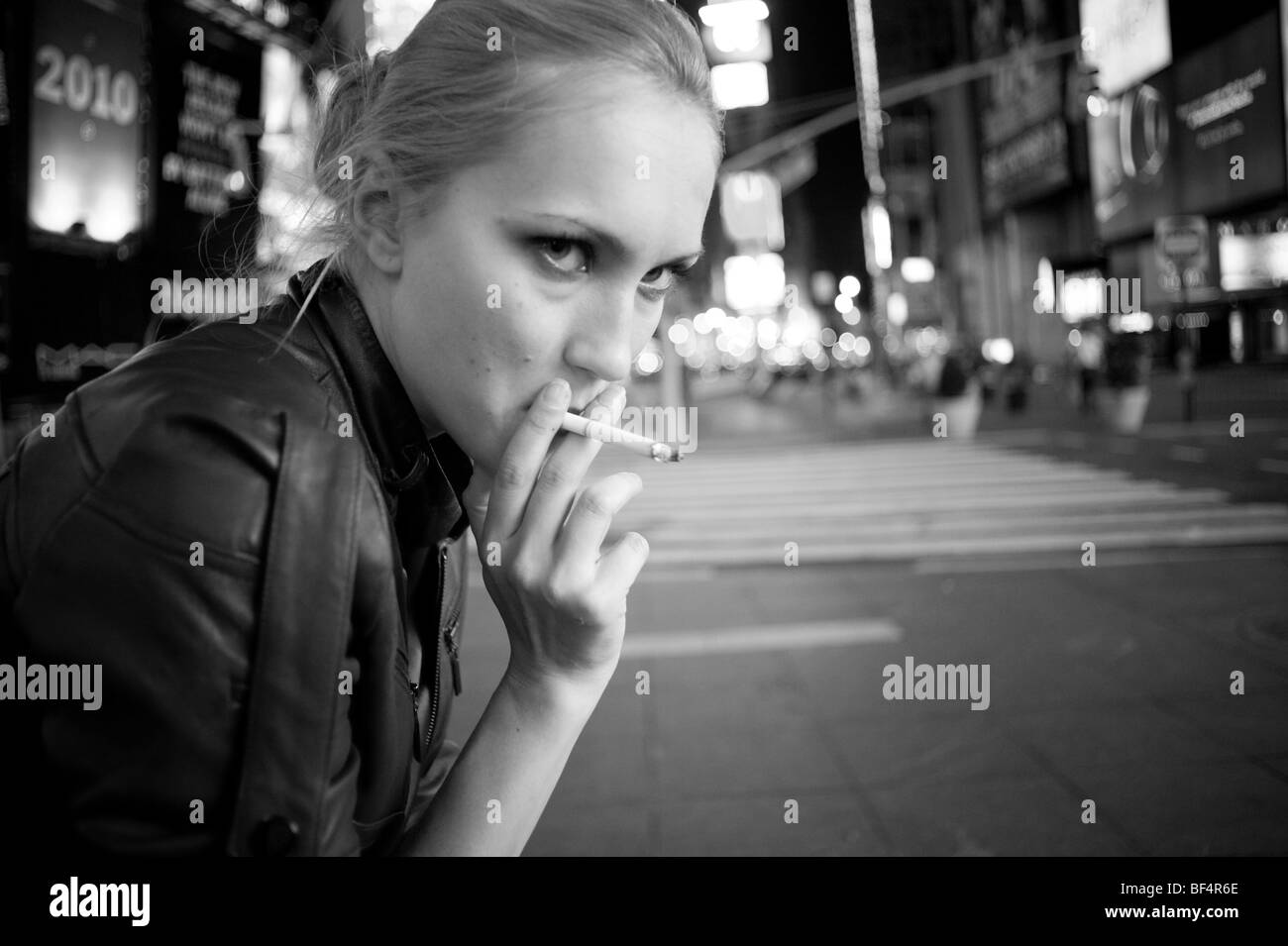 Woman smoking at night, New York City Stock Photo - Alamy