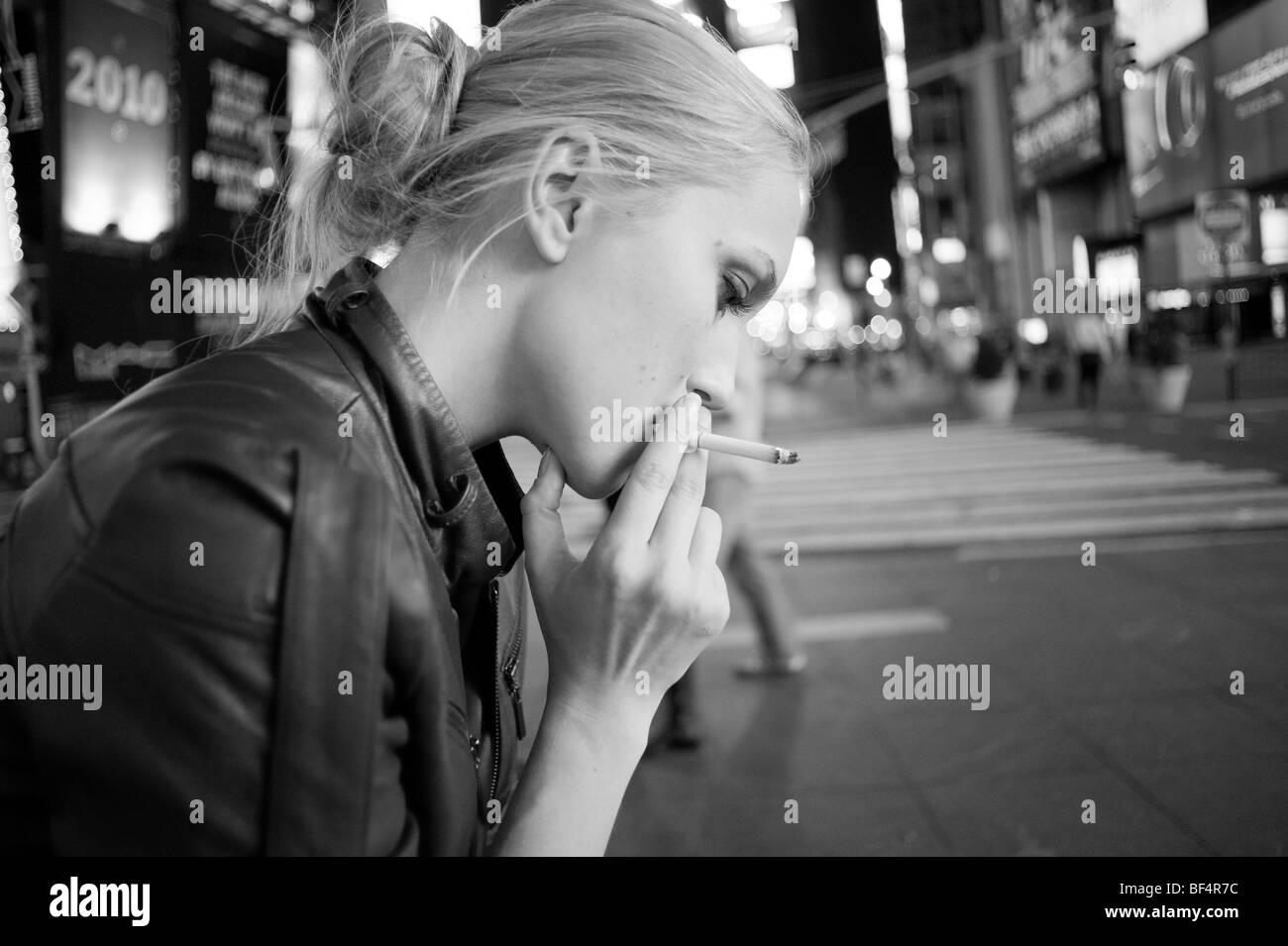 Woman smoking at night, New York City Stock Photo - Alamy