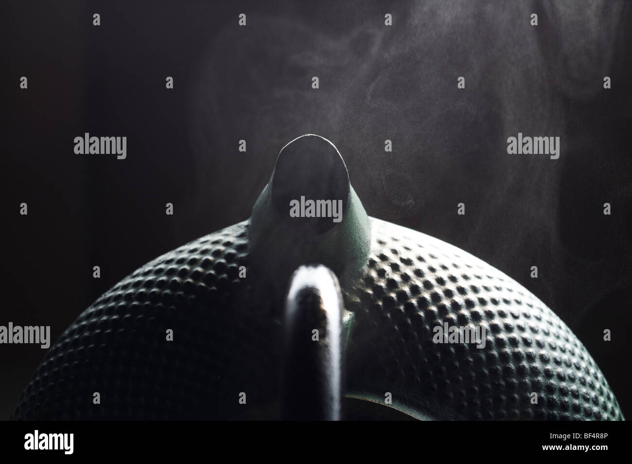 Cast iron teapot with steam coming out of the spout Stock Photo - Alamy