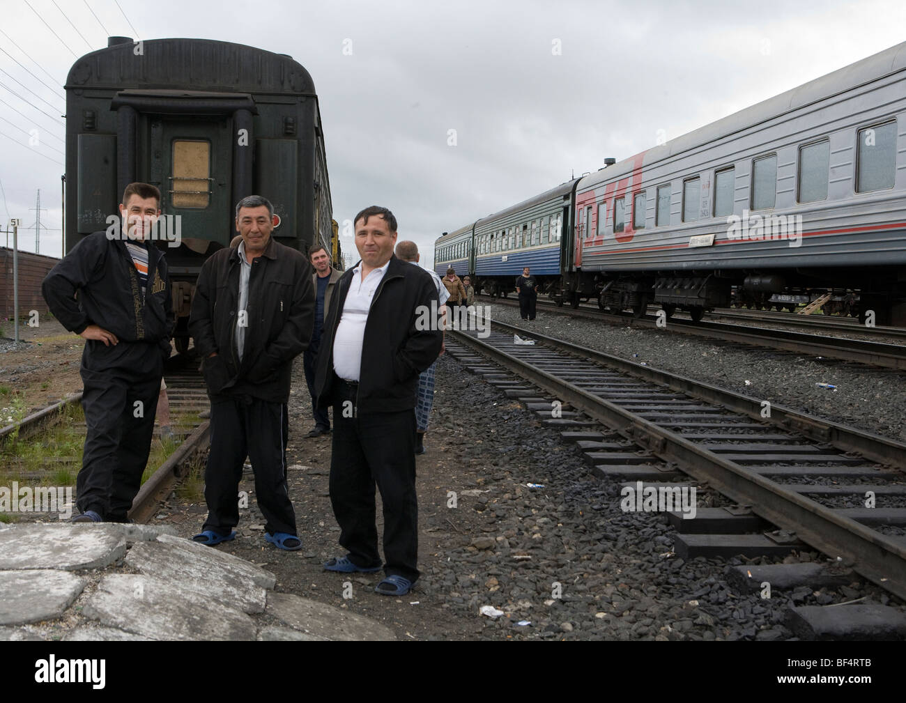 Railway workers on railway tracks by Russia arctic train in summer ...