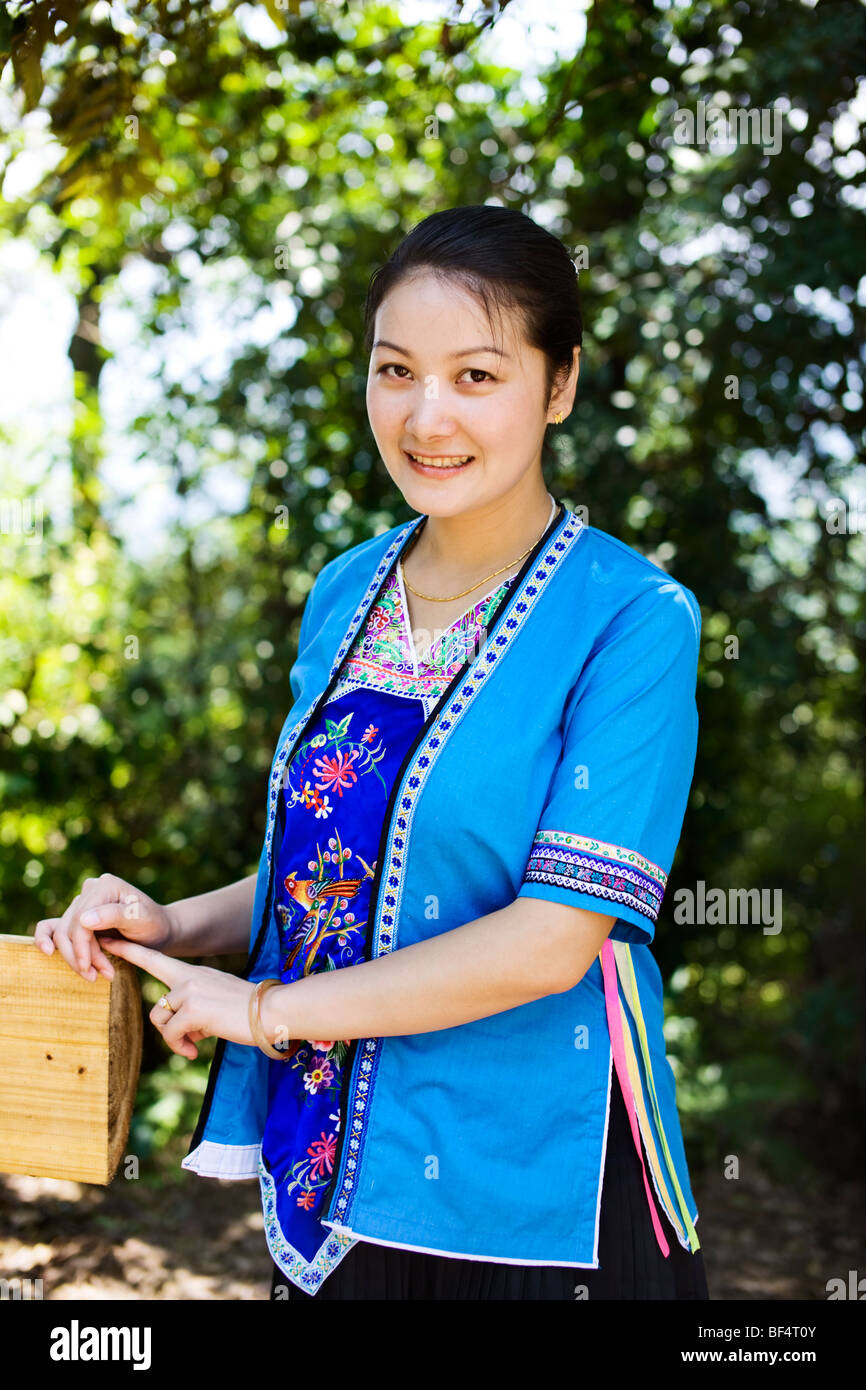 Smiling young Miao woman wearing traditional clothing, Qiandongnan Miao ...