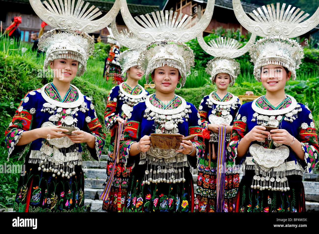 Miao young women in Miao traditional costume welcomes tourists with ...