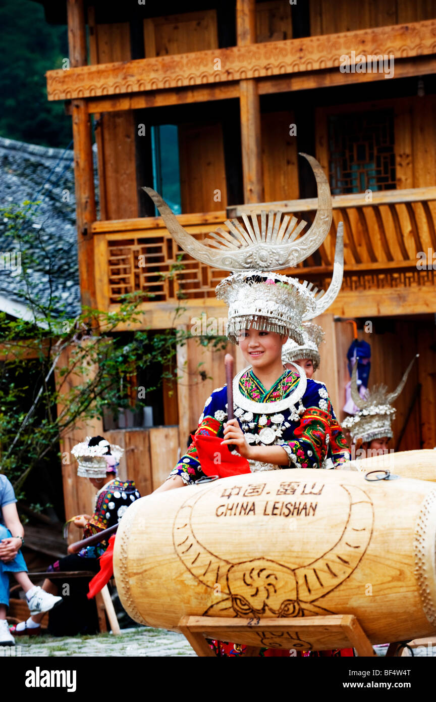 Miao young woman in Miao traditional costume performing drum dance ...