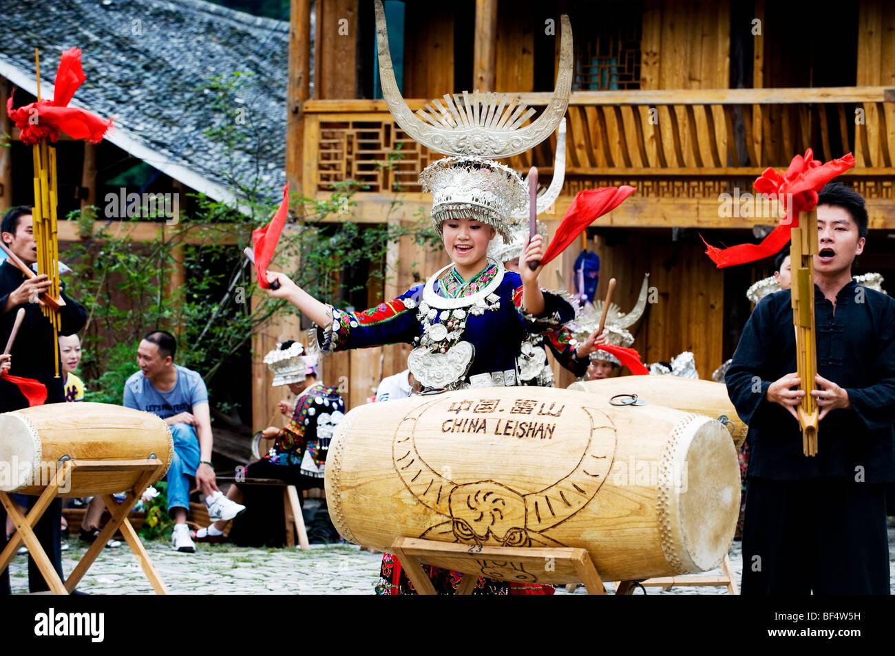 Miao young woman in Miao traditional costume performing drum dance ...