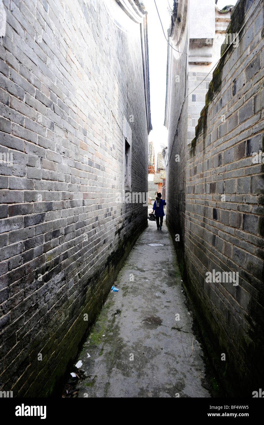 A Miao people walking in a narrow alley, Pingba County, Anshun City ...
