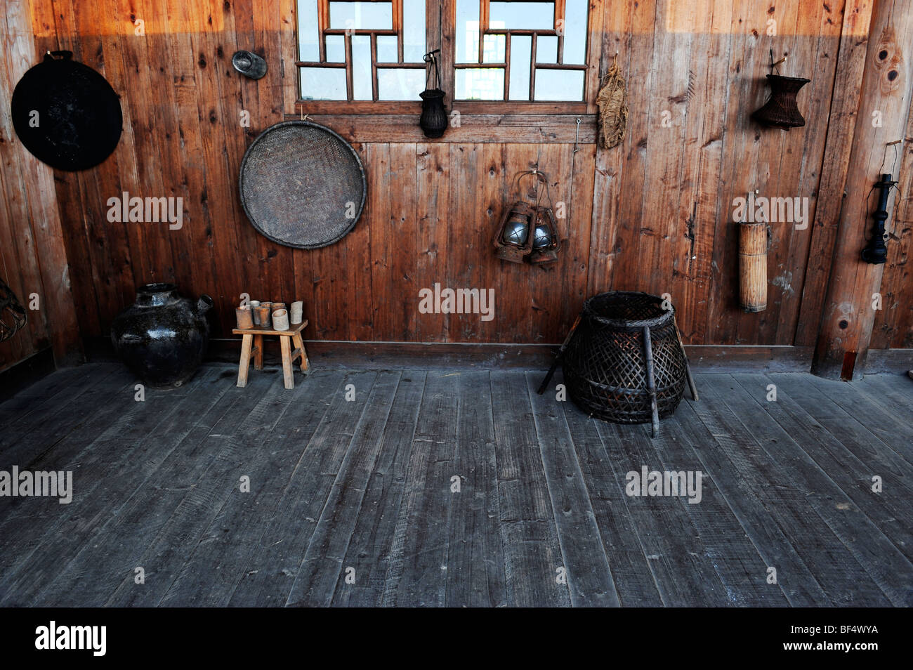 Tools used by Miao people hanging from wall of wooden house, Basha Miao ...