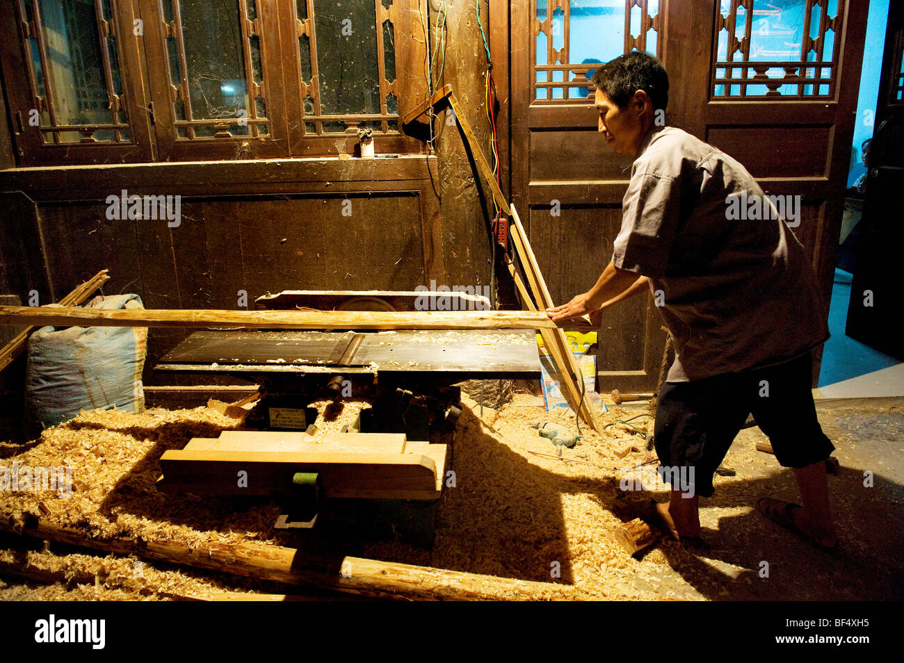 A Miao carpenter sawing wood, Zhaoxing Dong Village, Liping County ...