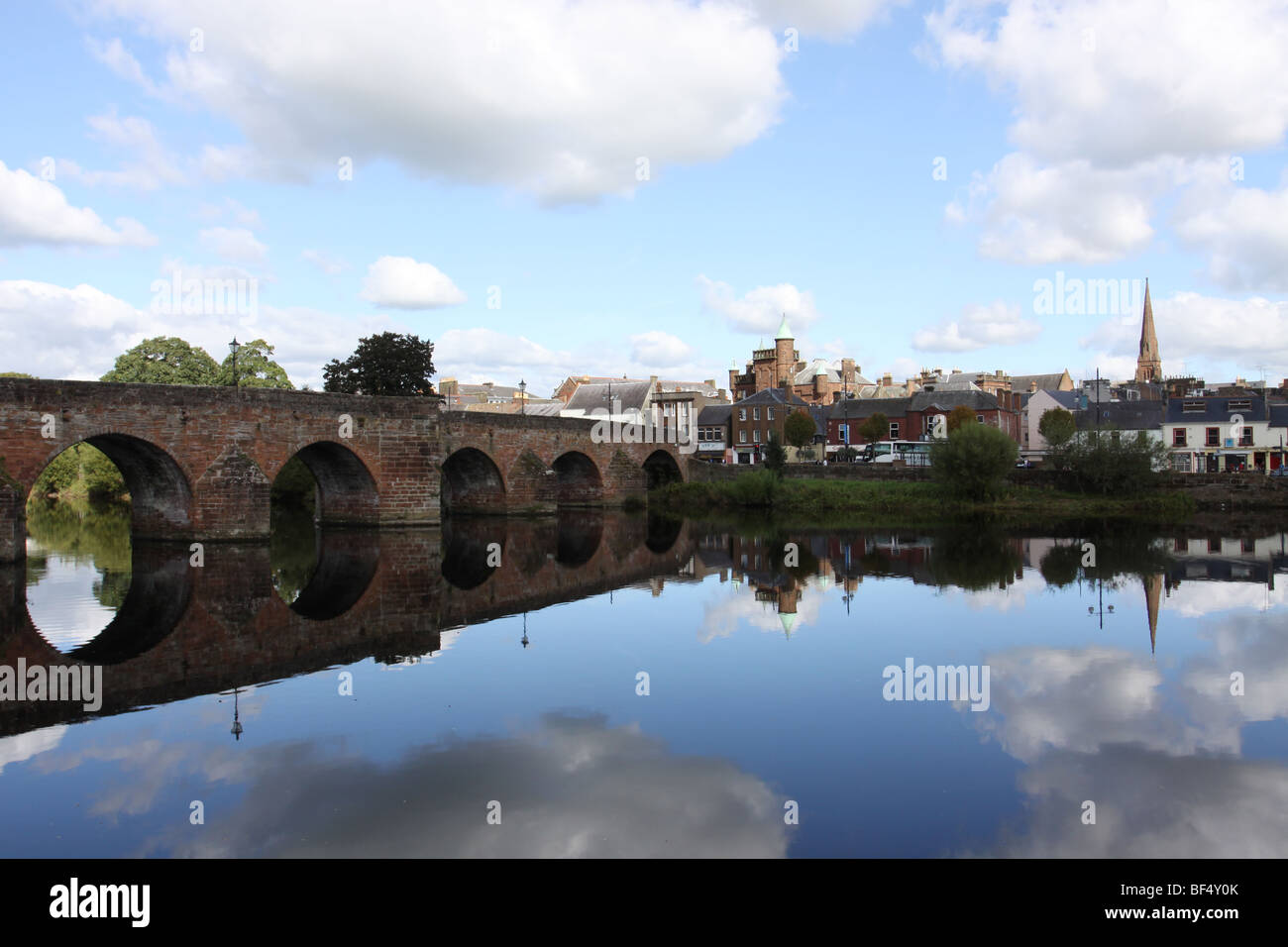 Devorgilla's Bridge reflected in River Nith and Dumfries skyline ...