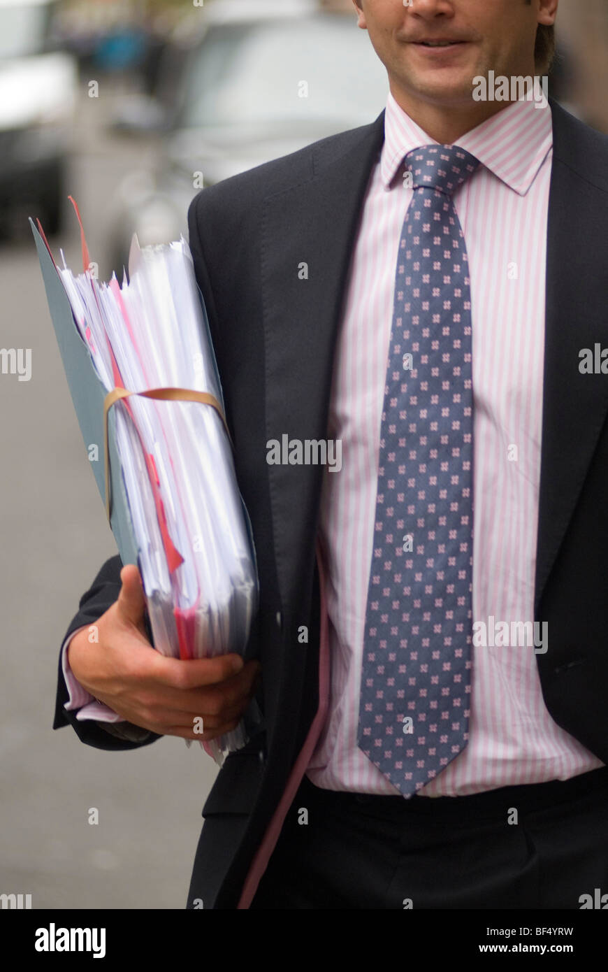 Paperwork, young office workers carrying a manila folder full of ...