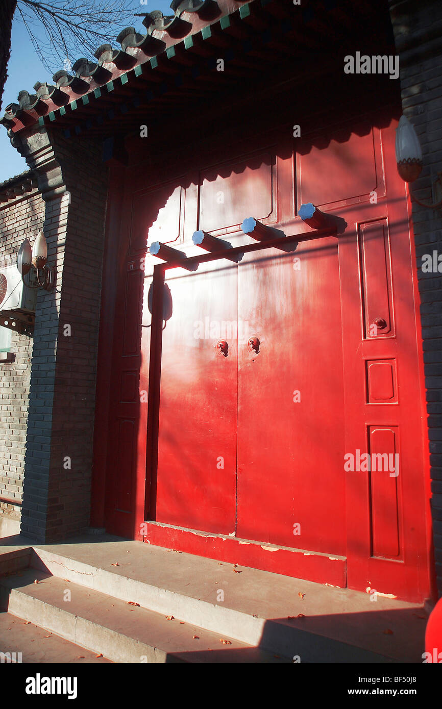 Red front gate of a courtyard house in a typical hutong, Beijing, China ...