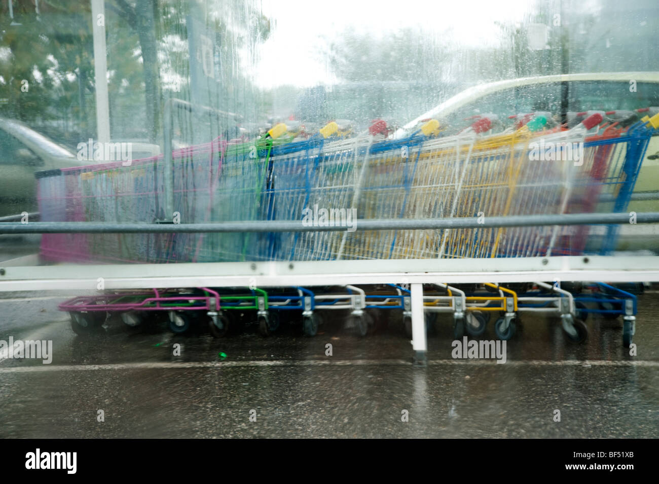 Colorful Shopping trolleys in rain Stock Photo - Alamy