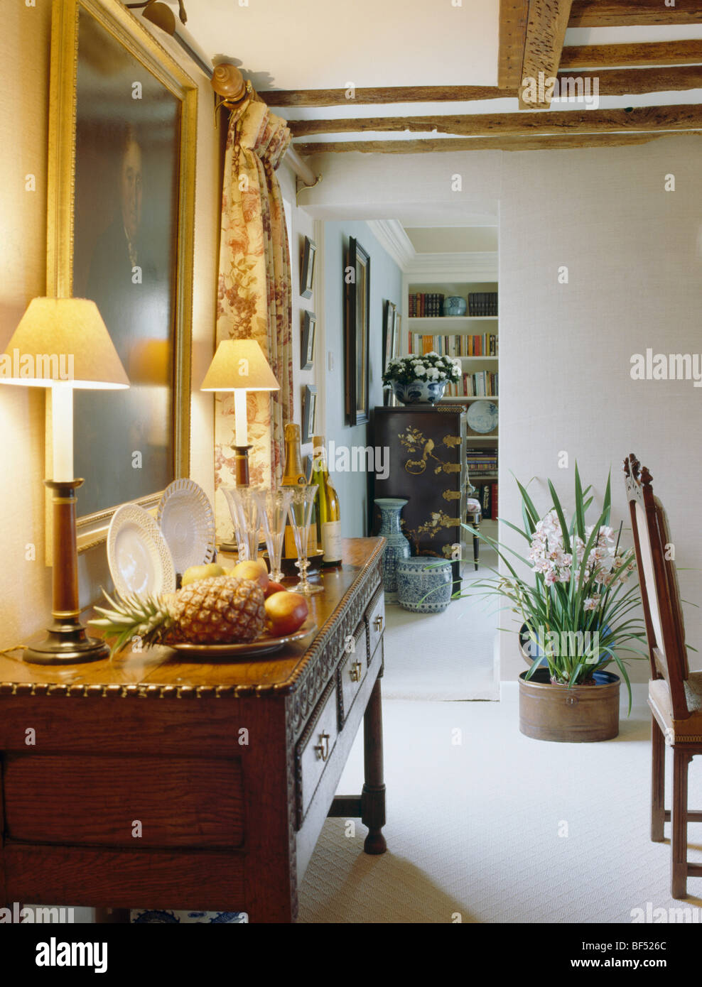 Sideways view of lighted lamps on console table in traditional hall ...