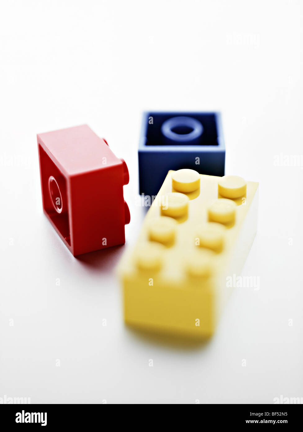 Three building bricks on white underground Stock Photo - Alamy