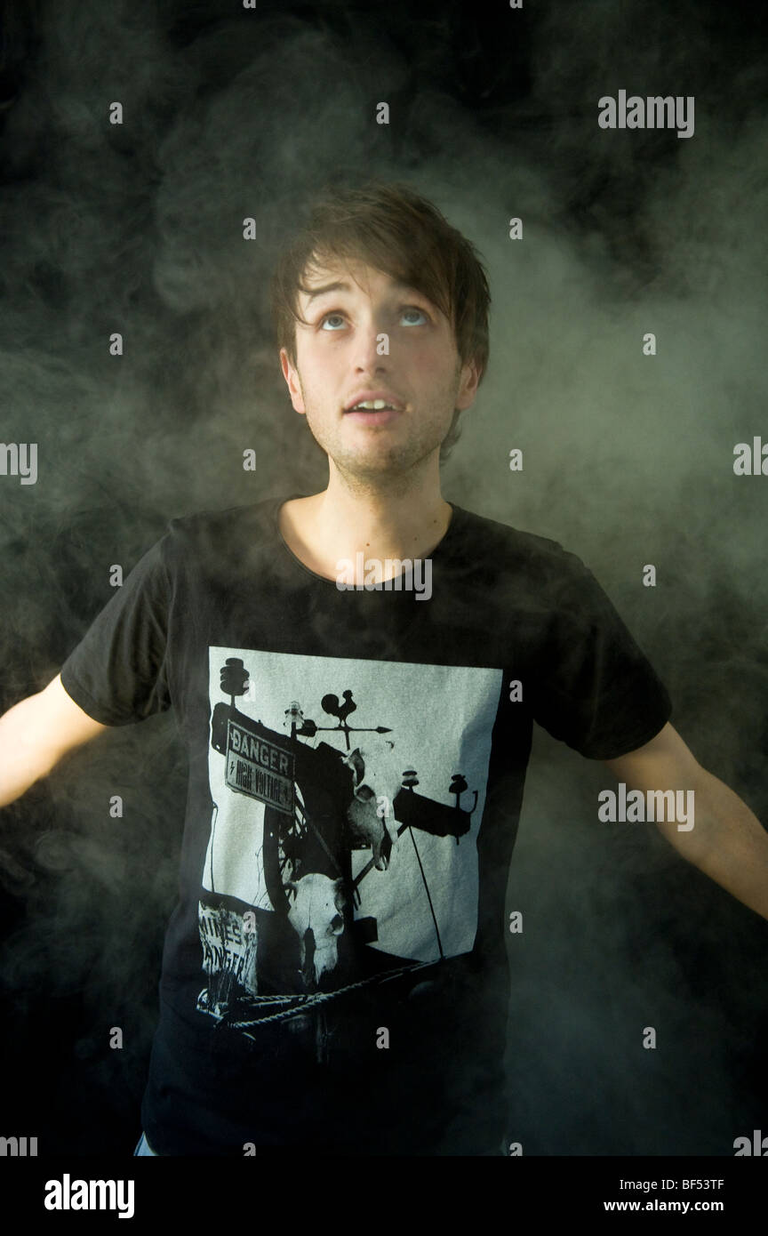 A young man poses in a smoky atmosphere Stock Photo - Alamy
