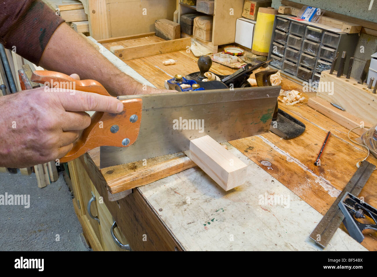 Sawing timber on home workbench Stock Photo - Alamy