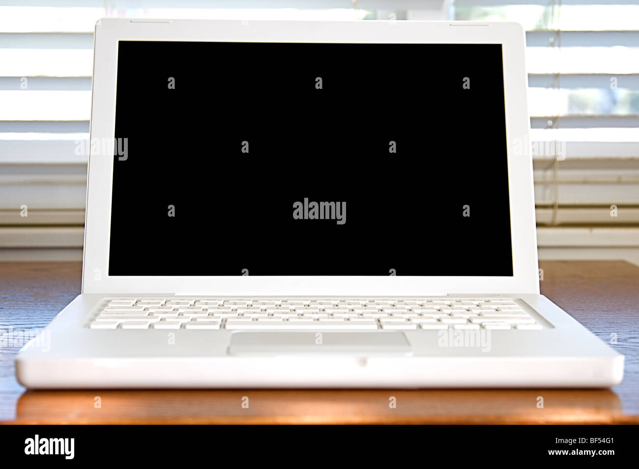 Working on a laptop computer sitting on a desk Stock Photo - Alamy