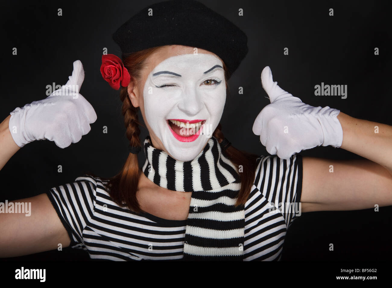 Portrait of a young lady dressed up as a mime isolated on white ...