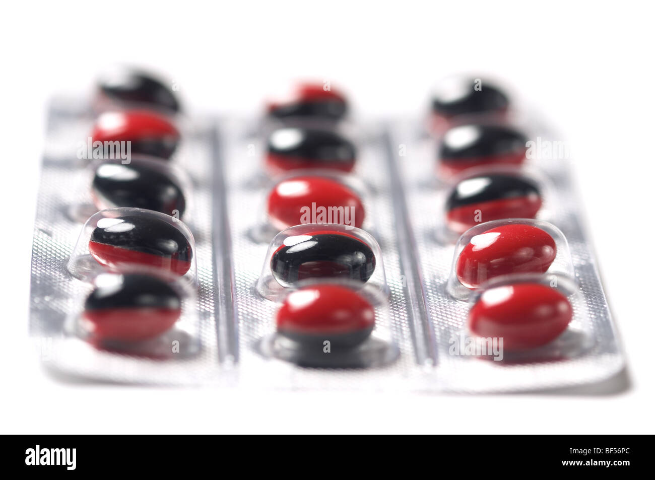 red-black pills on white background Stock Photo - Alamy